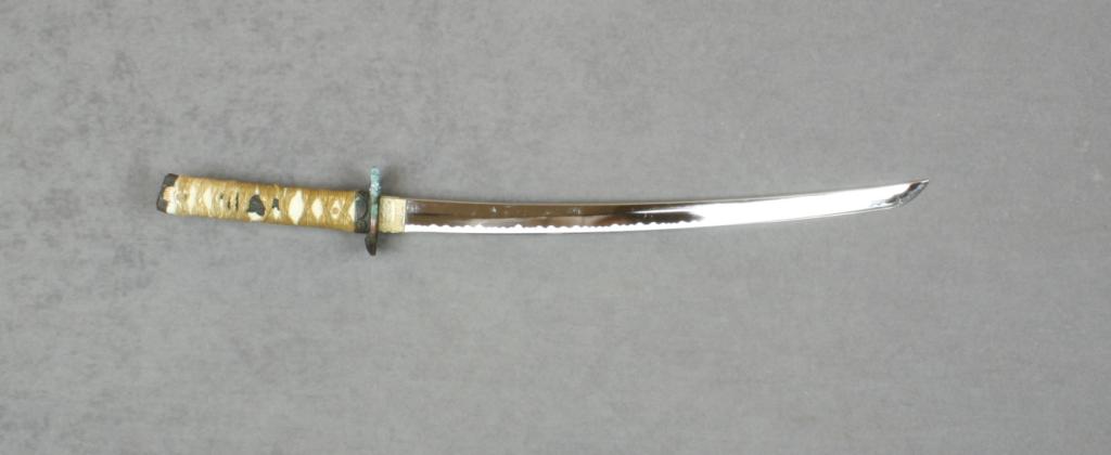 Short reproduction Samurai sword and scabbard; blade is very good, grip ...