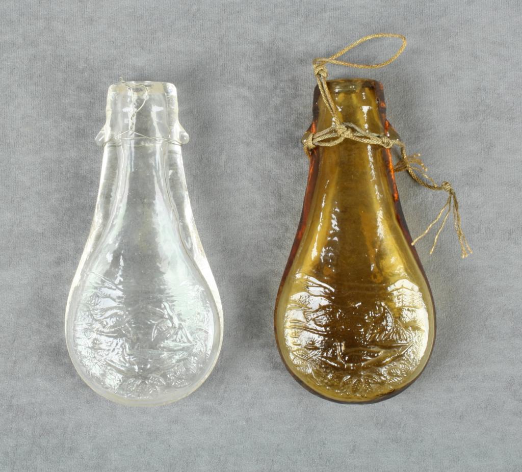Lot of two hand-blown glass powder flasks, one clear the other in a ...
