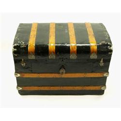 Antique steamer trunk on original rollers.