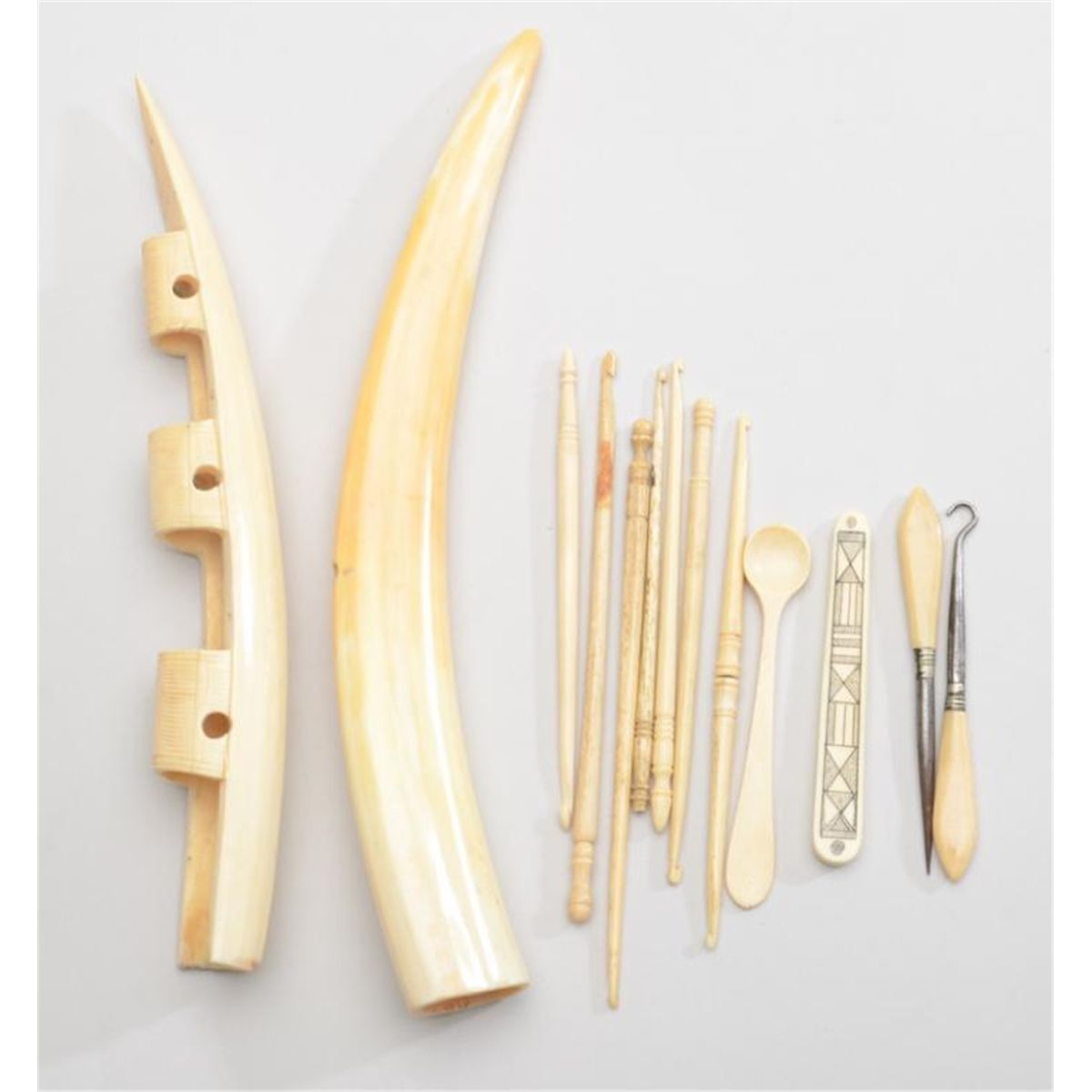 Marine ivory lot including a small tusk, a carved tusk in the form of a ...