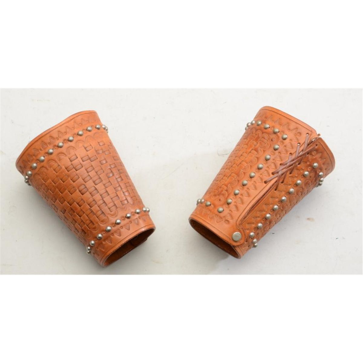 Pair of modern tooled leather gauntlets in overall fine condition. Est ...