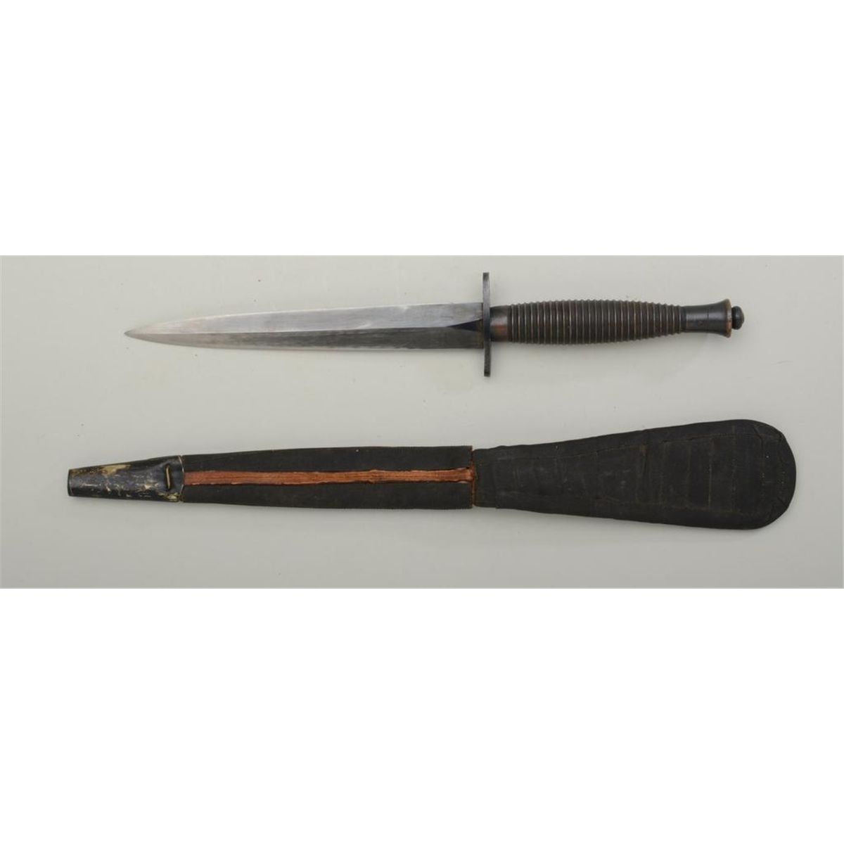 Military style dagger with tape wrapped sheath and metal tip, approx ...
