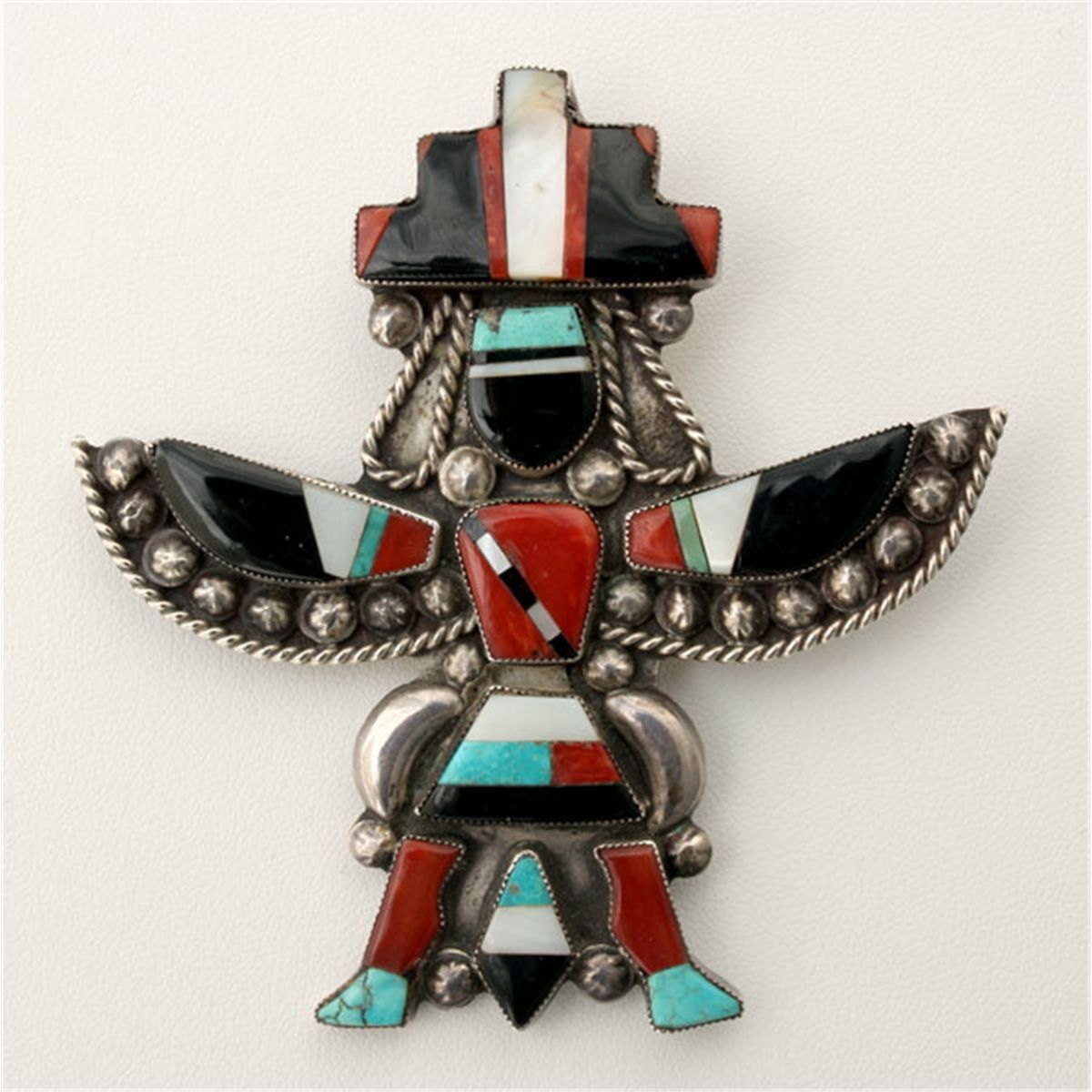 ZUNI SILVER, MULTI-STONE, KNIFEWING MAN BROOCH.