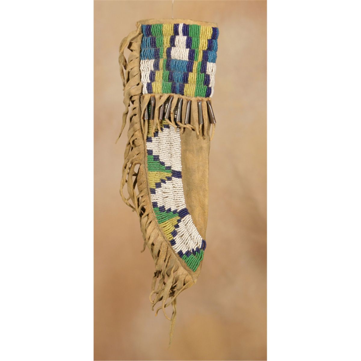 Beaded knife case with tin cone tassels.