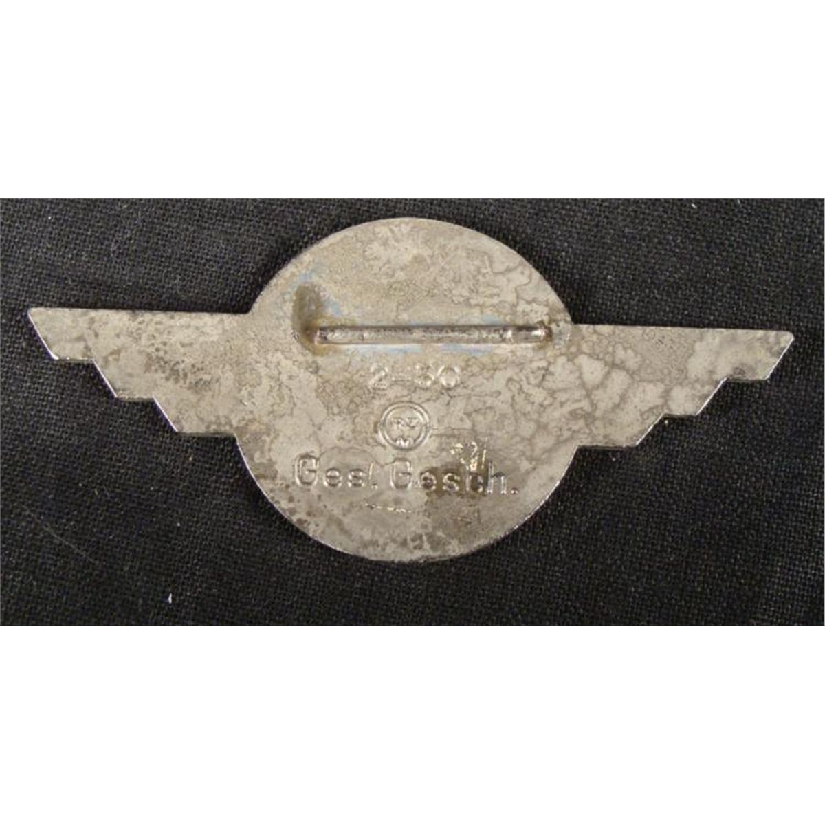 NAZI DLV BADGE WITH AN ENAMEL BACKGROUND AND SWASTIKA