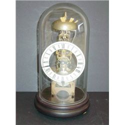 Small skeleton clock under glass dome