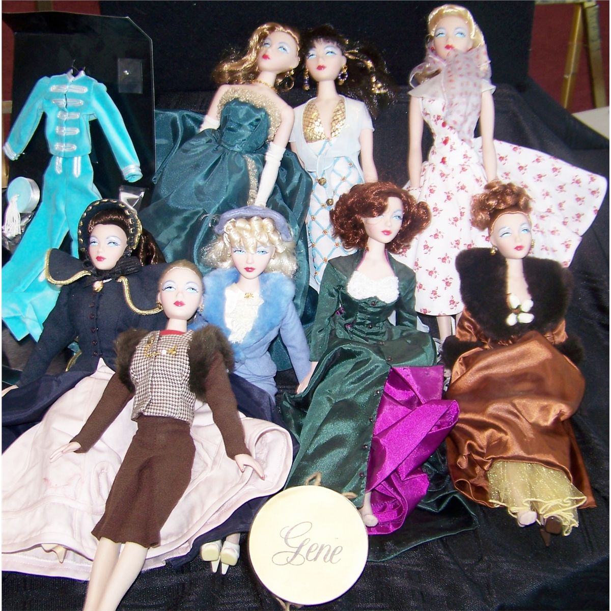 Eight GENE Collectible Dolls w/ Accessories & (1) Set of Clothes as Shown.