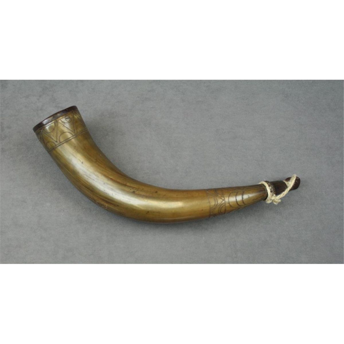 Carved large powder horn, approx. 15” overall with wood base and spout ...