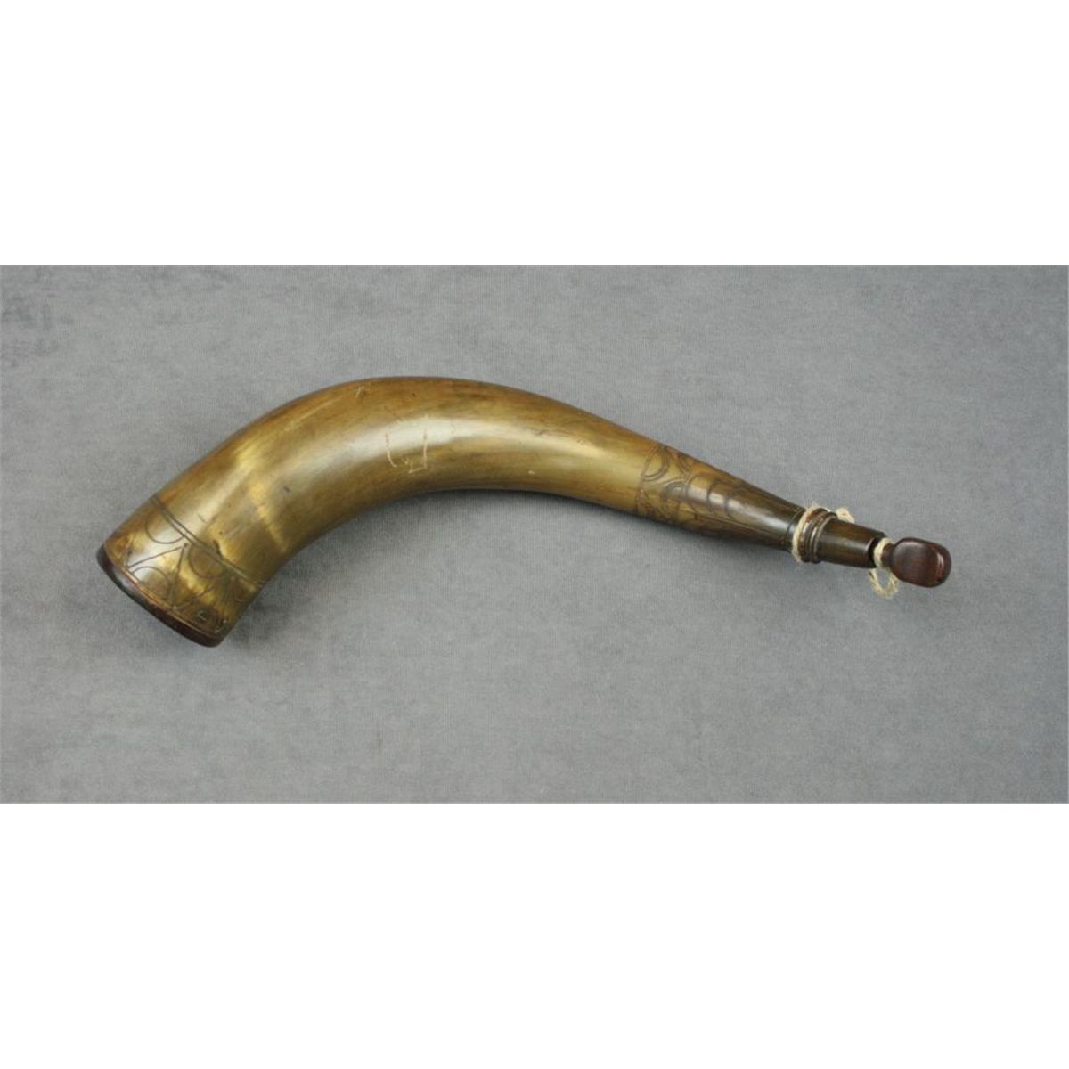 Carved large powder horn, approx. 15” overall with wood base and spout ...