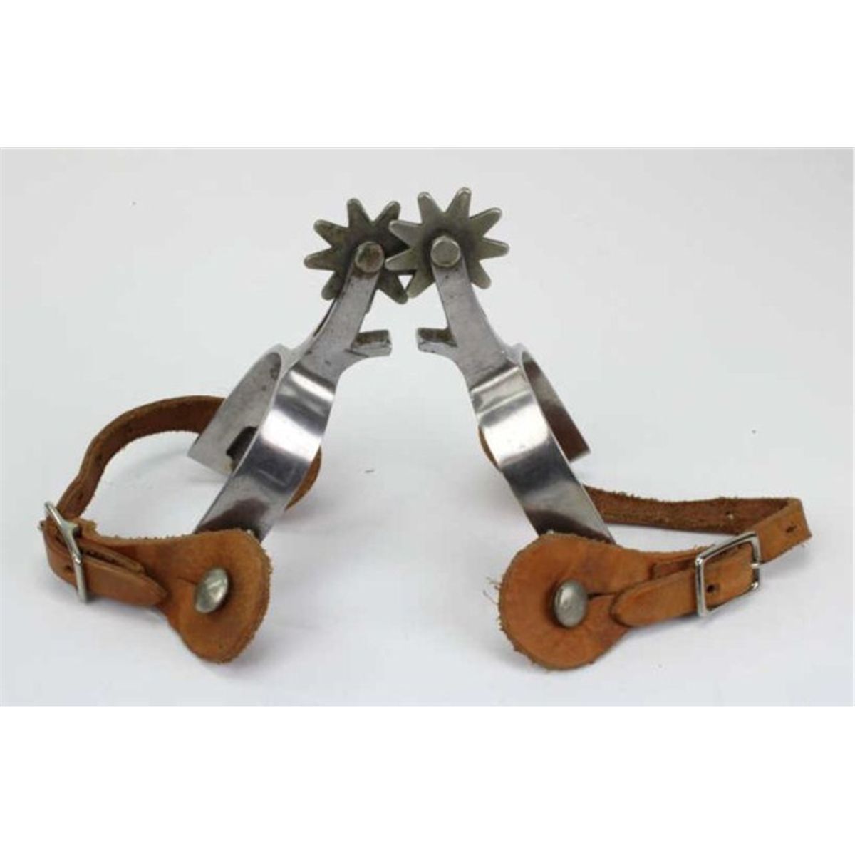 One pair Crockett marked cowboy spurs with 9 point rowels and leathers ...