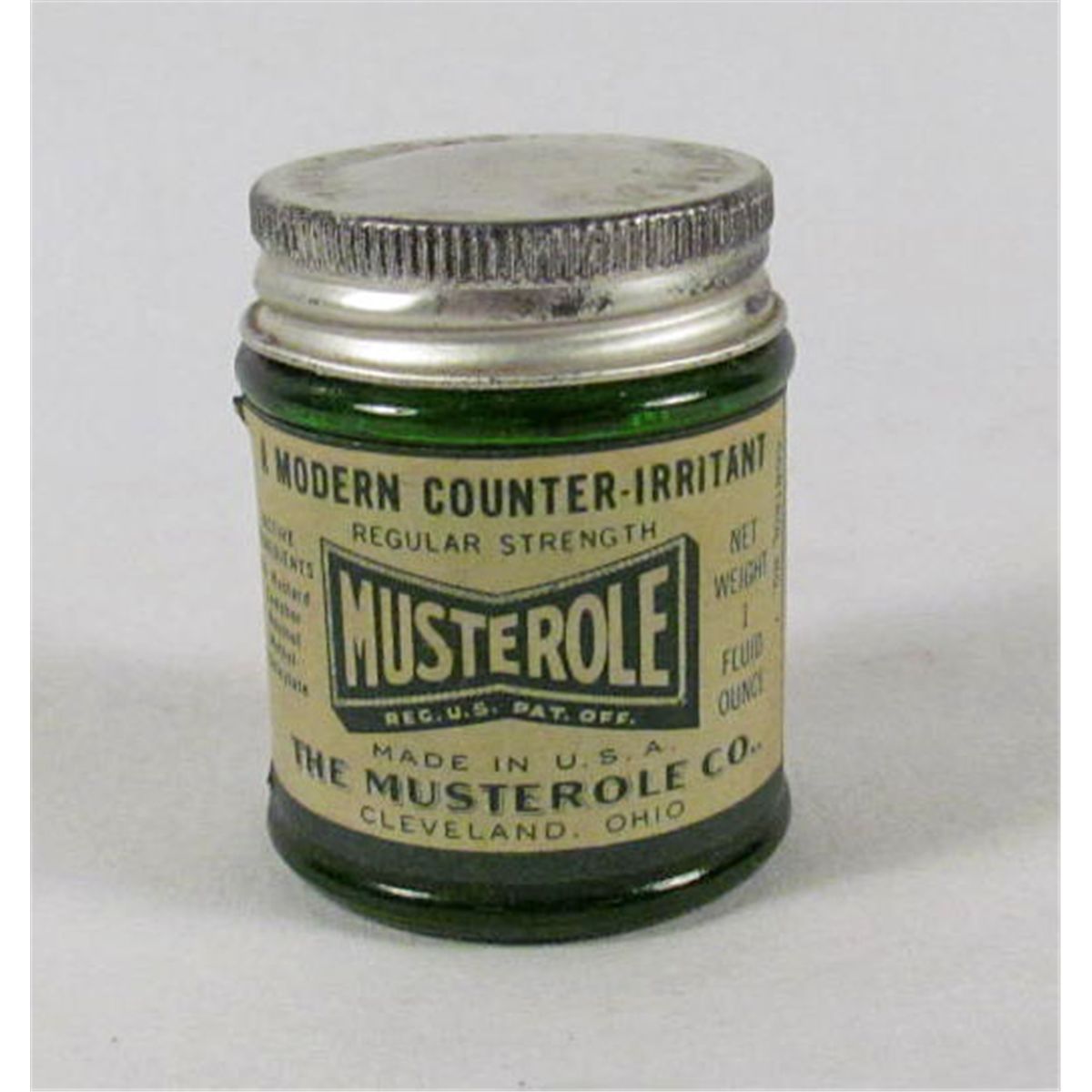 4107 - GREEN GLASS ADVERTISING JAR "MUSTEROLE, A MODERN COUNTER-IRRITANT"