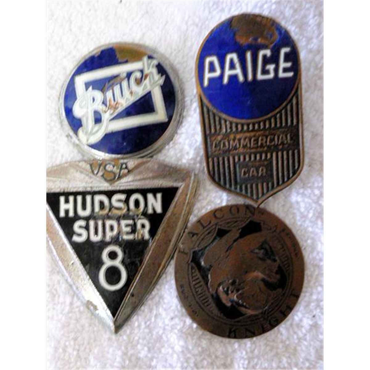 4 antique car emblems