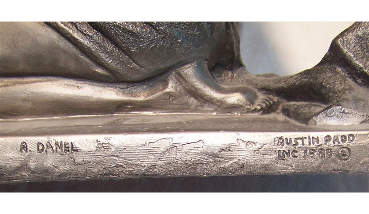 A. Daniel Austin Prod Lady Statue.