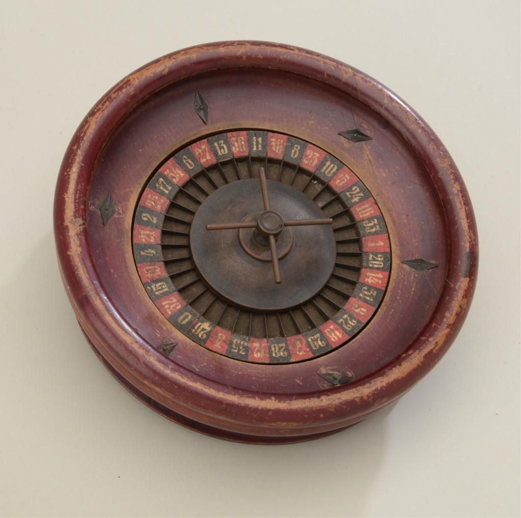 Old small portable roulette wheel made of hardwood and with brass ...