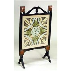 An unusual Arts and Crafts dark stained oak embroidered fire screen, possibly continental, the shape