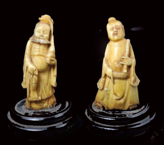 2 carved bone Chinese figures on teakwood stands