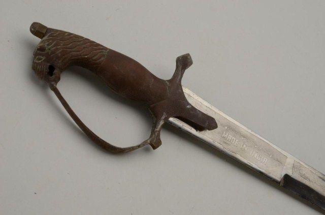 Curved blade sword and red material covered metal scabbard with hanging ...