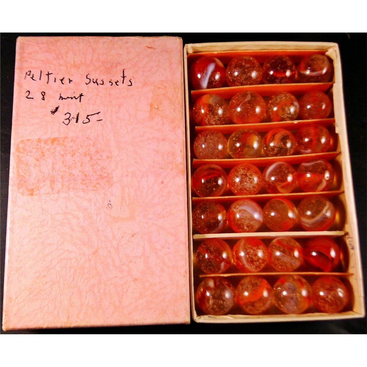 Marbles: Lot 107. 27 Peltier Sunsets in a jobber box.