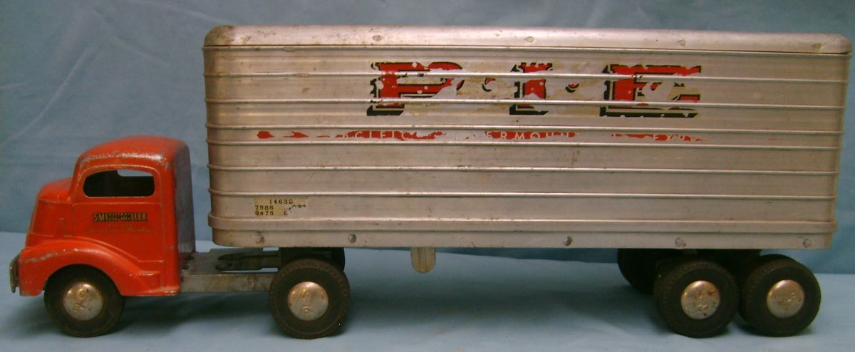 2 toys: SMITH MILLER, P.I.E., semi tractor & trailer, 14”L; WYANDOTTE ...