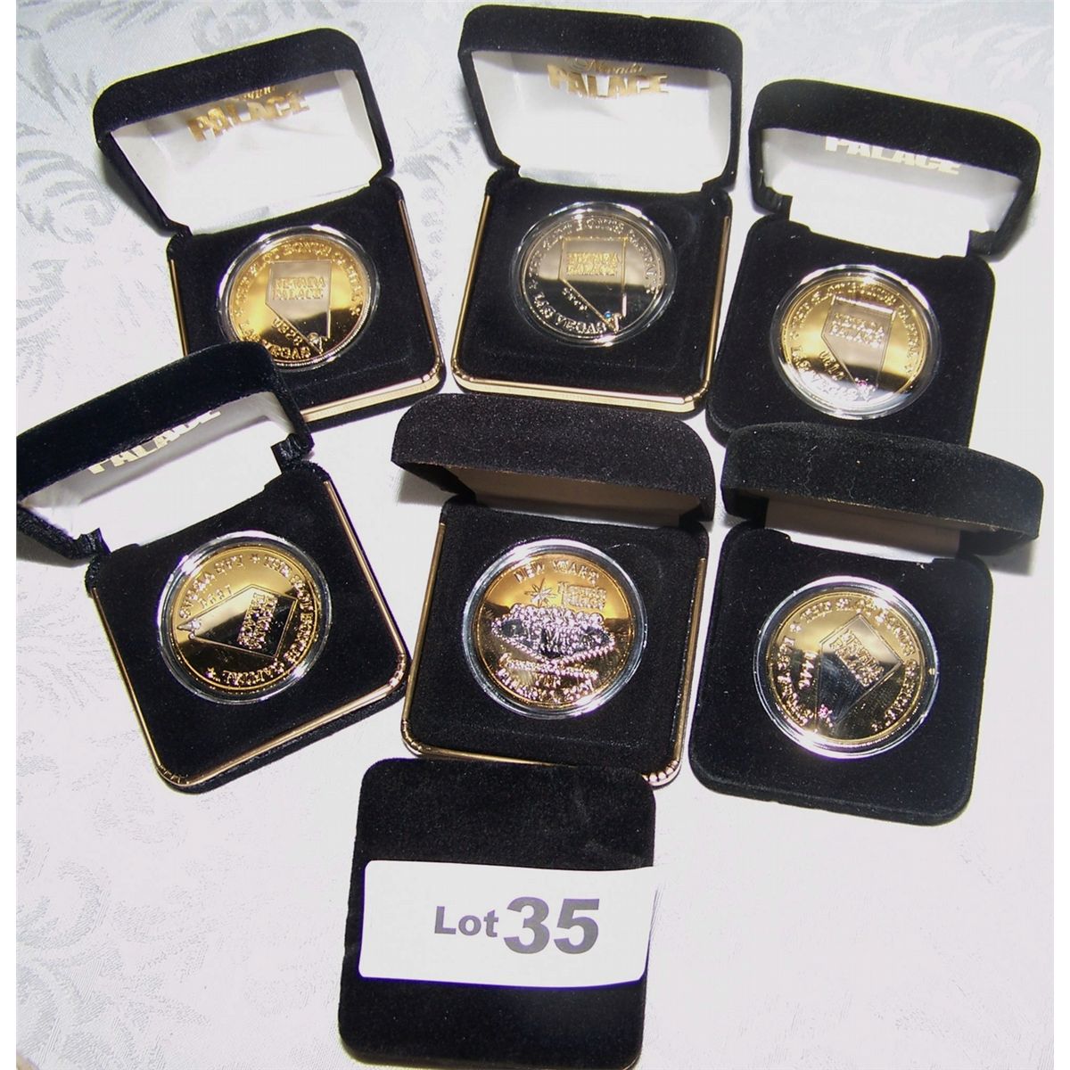 (7X$) NEVADA PALACE GOLD LAYERED COMMEMORATIVE COINS