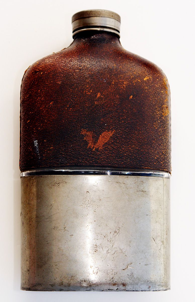 2 items: Solid brass traveling spittoon; 1890's leather covered whiskey ...