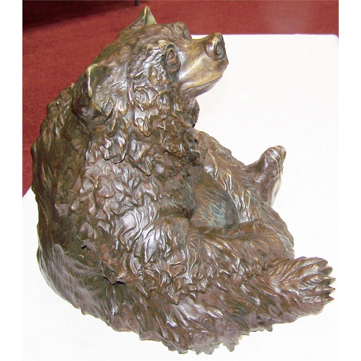 RICK ROWLEY SEATED BRONZE BEAR SCULPTURE, 16T X 17L X 18D