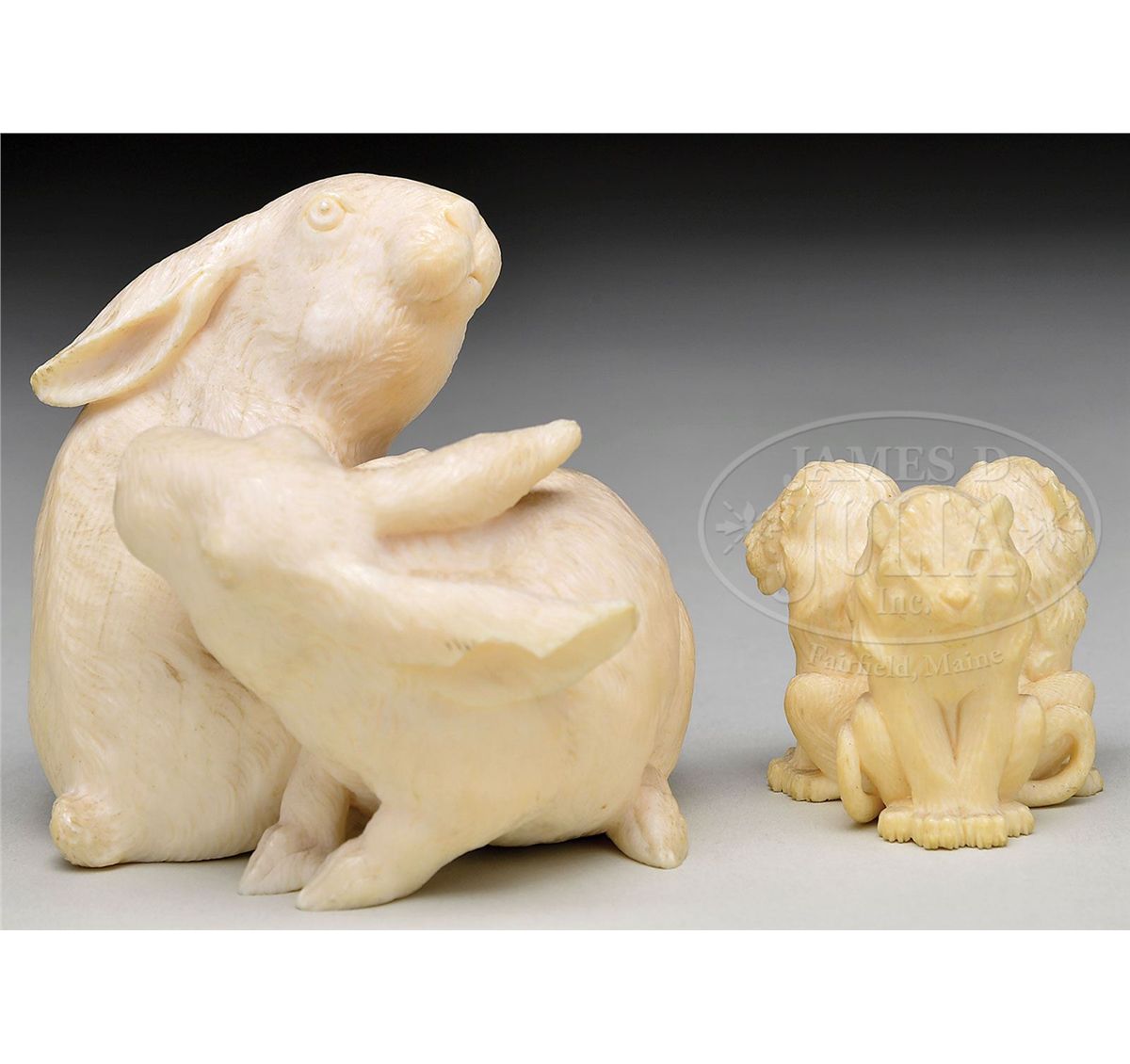 TWO CARVED IVORY FIGURAL GROUPS OF ANIMALS.