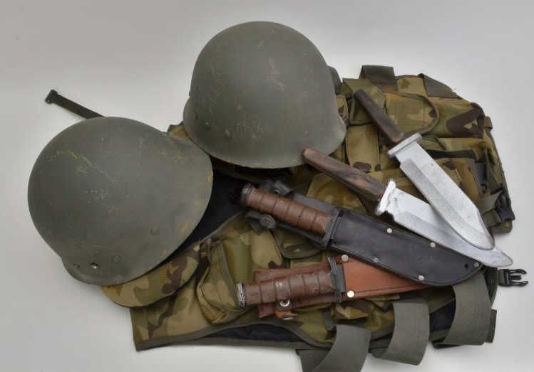 Lot of movie military props including three helmets, a camo field vest ...