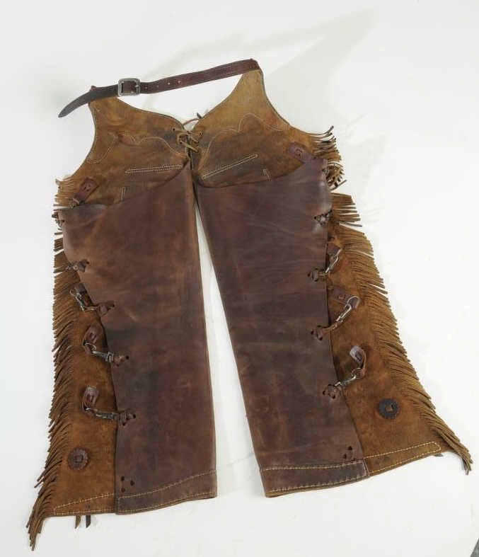 Pair of wide flared chaps with long fringe mounted with 6 nickel silver ...