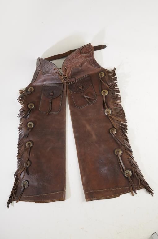 Pair of wide flared chaps with long fringe mounted with 6 nickel silver ...