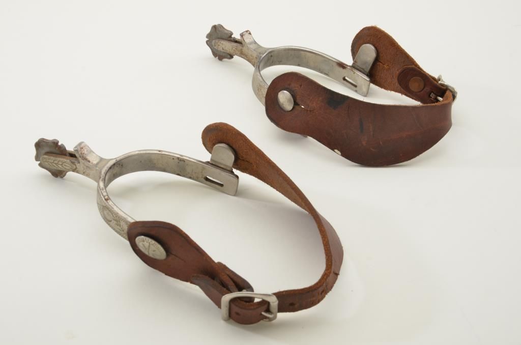 Pair of Crockett marked Western-style spurs showing a light line ...
