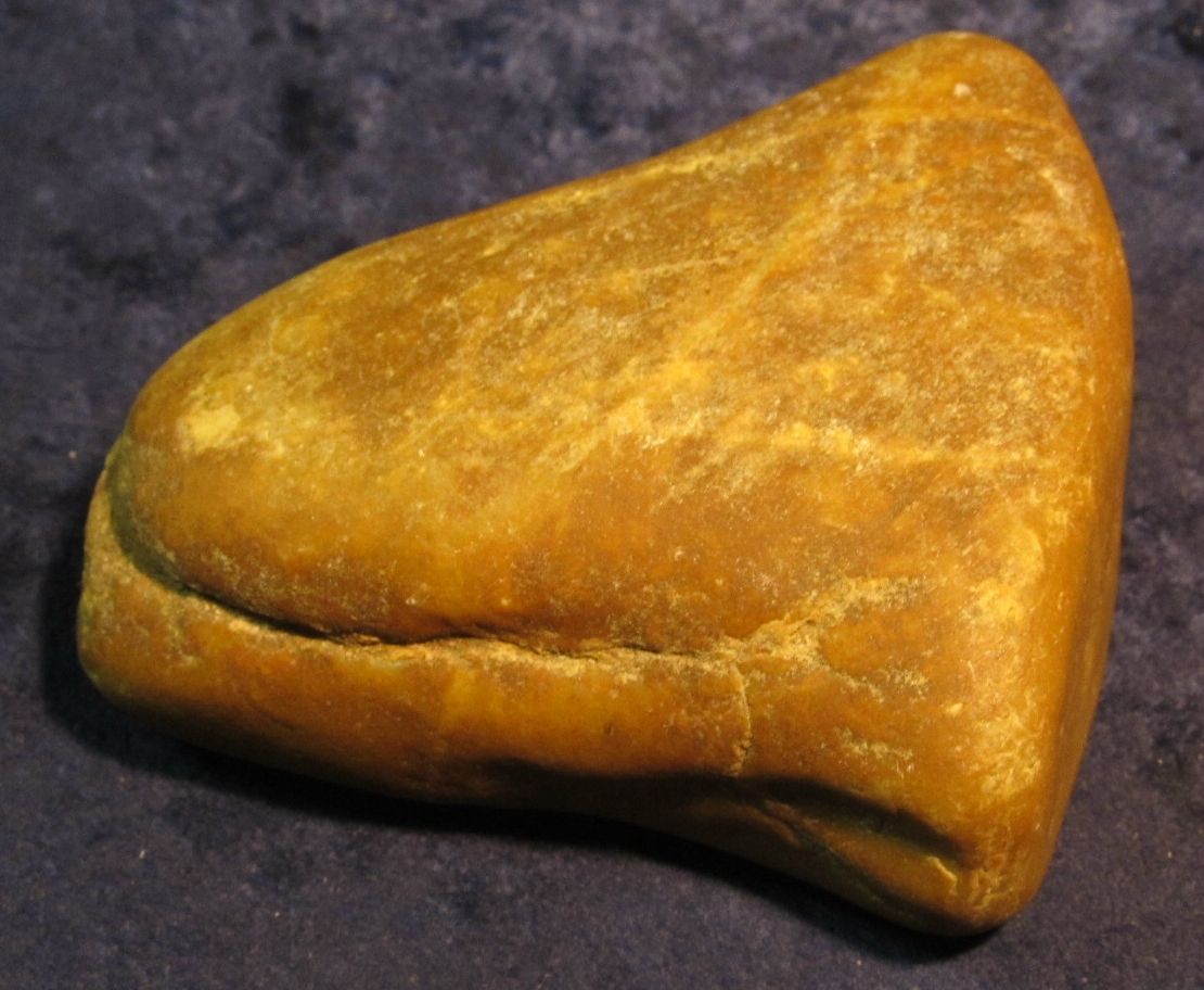 789. Quartzite Mano, which is a smooth hand-held stone used against a ...