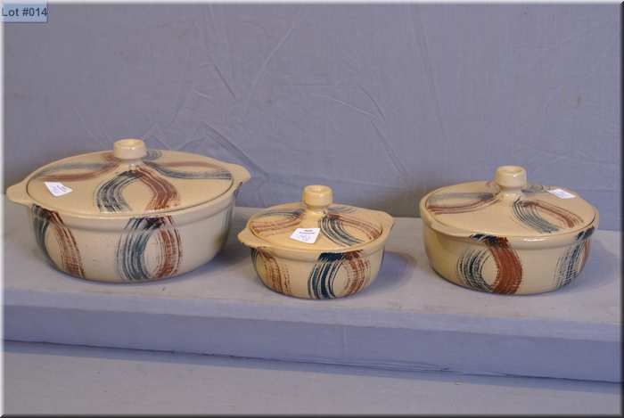 Three lidded Medalta casserole dishes in graduated sizes