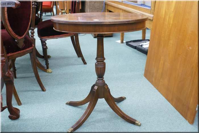 A mid 20th century single pedestal mahogany occasional table with brass ...