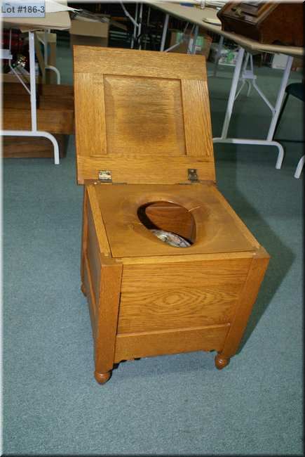 An antique oak commode with a "Ridgewood and Son" England lidded ...