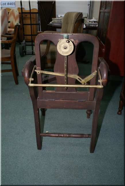 Antique wooden barber chair with reclining mechanism made by Centrifical