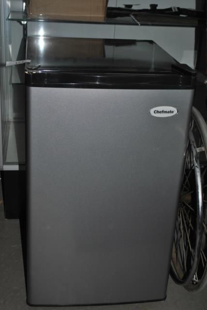 A small black and silver mini fridge by Chefmate