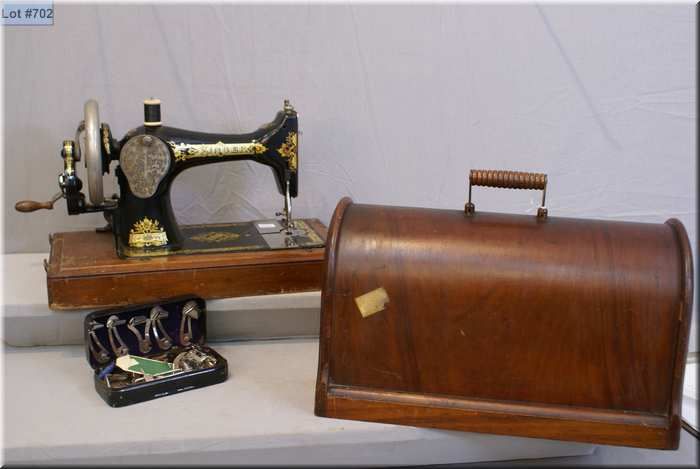 Antique Singer portable sewing machine in a wooden carrying case