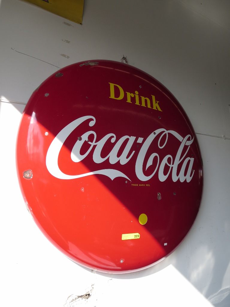 Giant red, round metal Coca-Cola sign