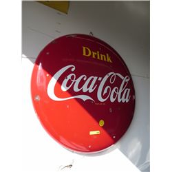 Giant red, round metal Coca-Cola sign