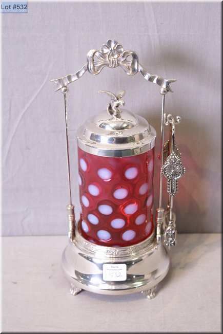 A cranberry and milk glass polka dot pickle castor in silver plate ...