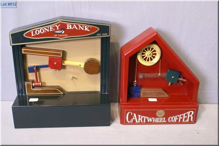 Two modern wooden mechanical loonie banks
