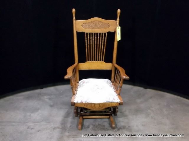 PRESSED & SPINDLE BACK CARVED OAK GLIDER ROCKER W/ FLORAL CUSHION