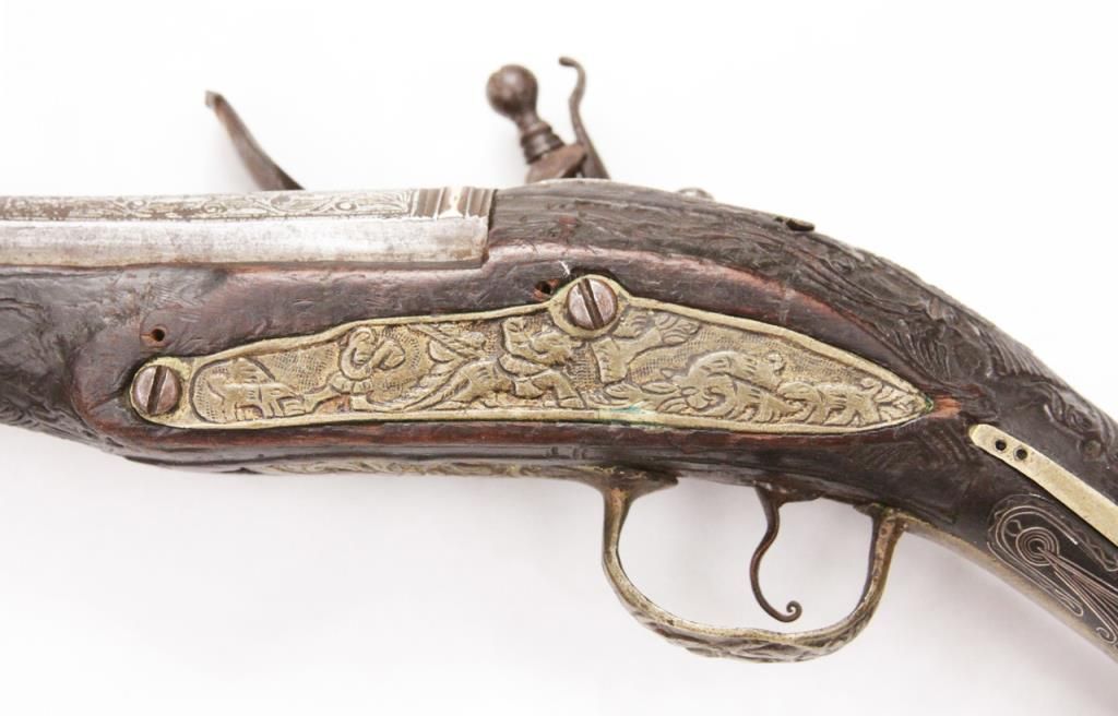 An Ottoman flintlock pistol with well carved stock and silver inlays ...