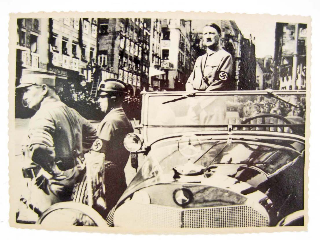 PHOTOGRAPH OF ADOLF HITLER STANDING IN A CAR