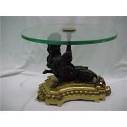 Round glass top table with bronze figure of a sphinx on gilt metal base ...