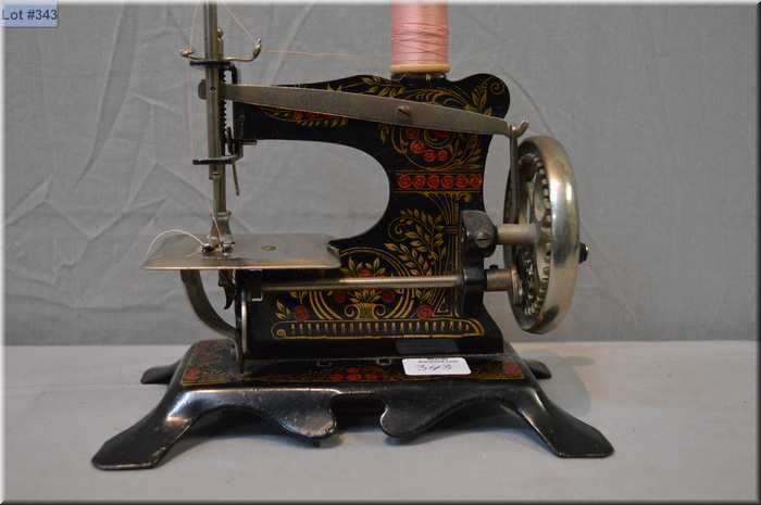 Child's vintage cast sewing machine, with great original litho
