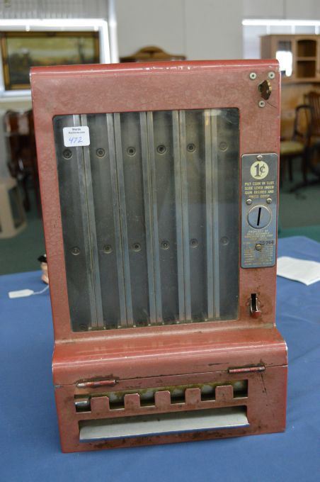 Vintage metal coin operated candy dispenser with key