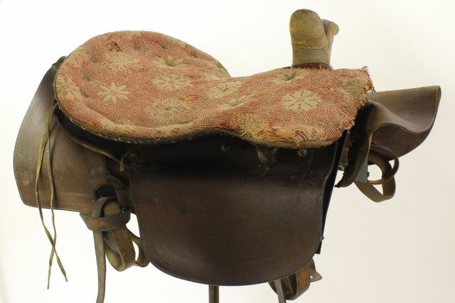 Antique ladies side saddle with padded cloth seat,