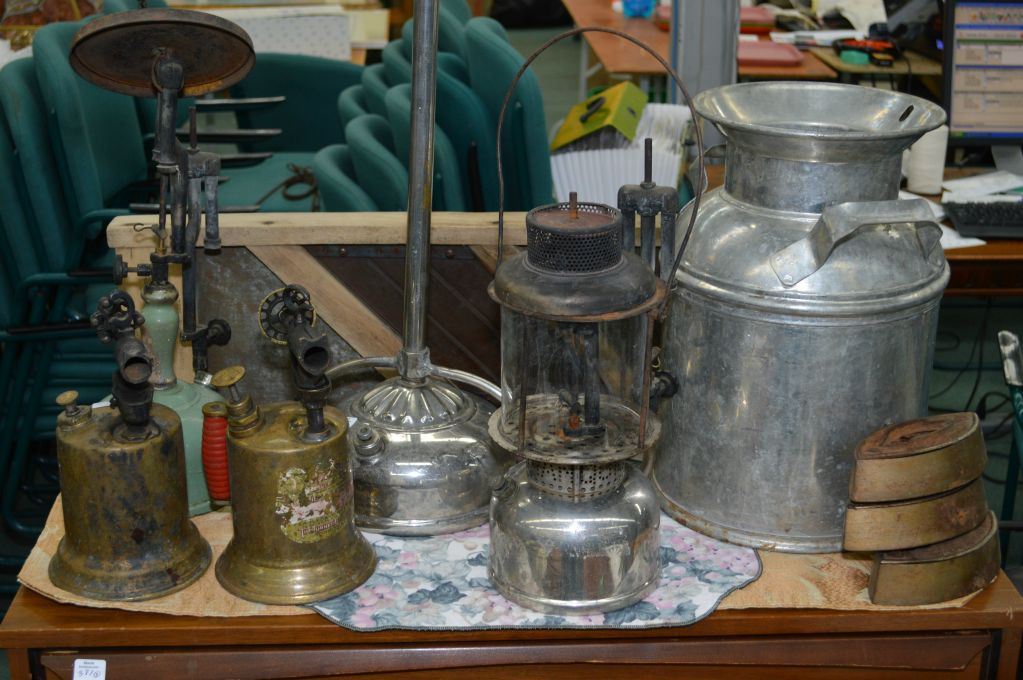 Selection of primitive collectibles including sadirons, torches ...